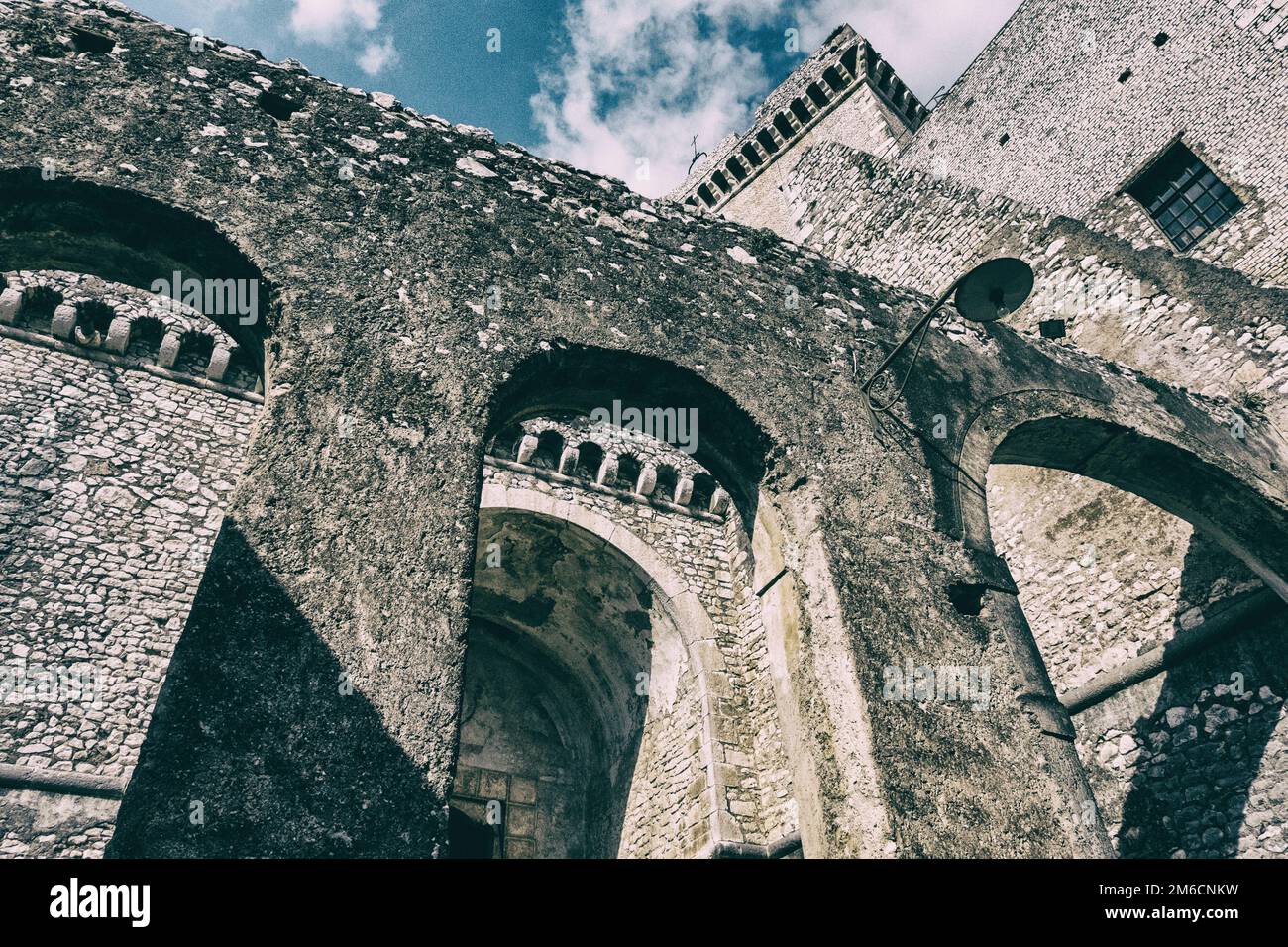 Arches of a medieval castle with blue sky and clouds background Stock ...