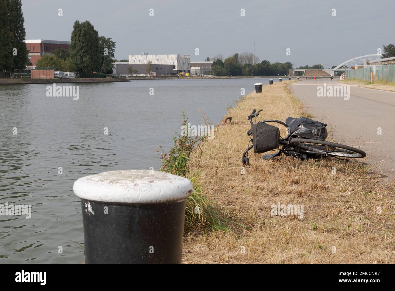 The bike lies on the bank of a water channel Stock Photo - Alamy