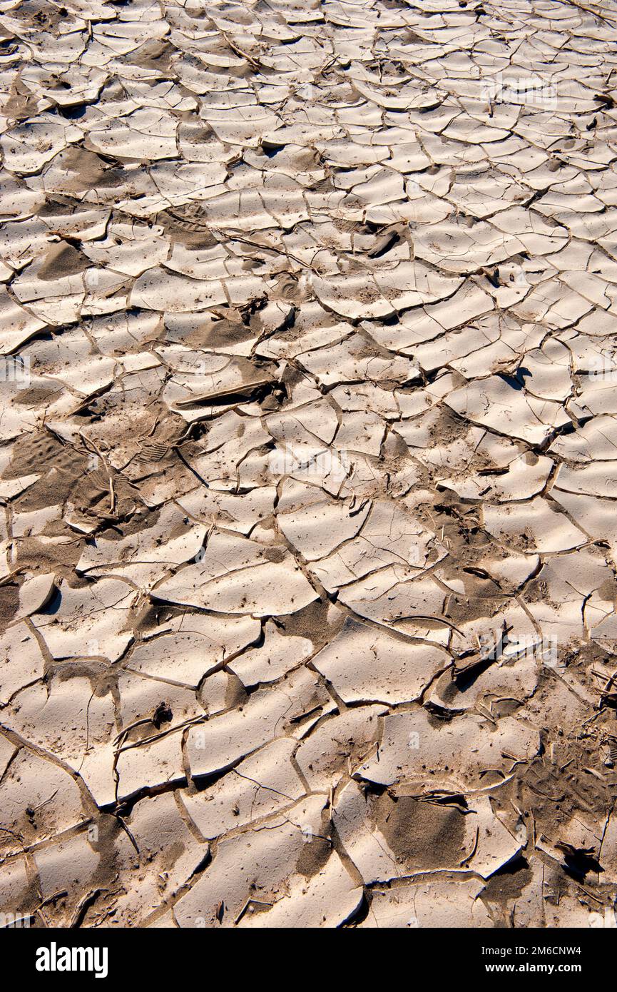 Dried and cracked earth in a riverbed in the desert at Death Valley, CA ...