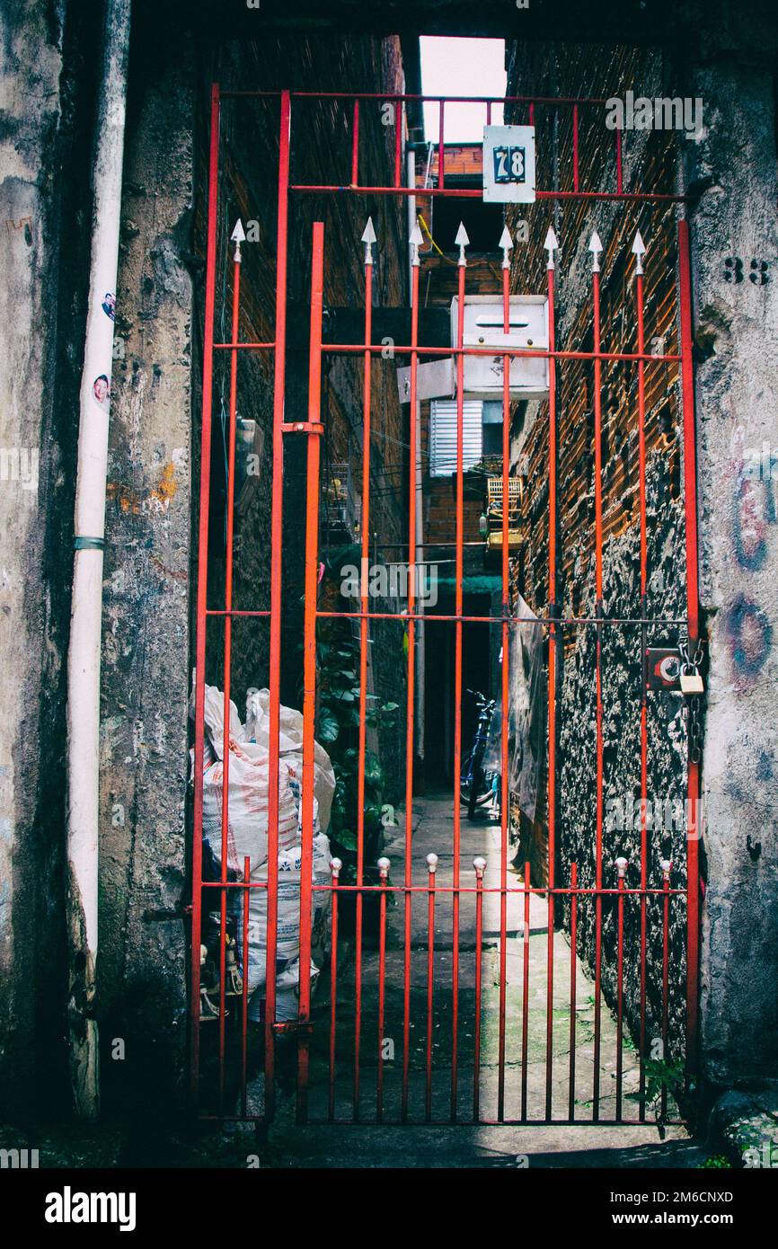 Red metal gate of a favela in Brazil Stock Photo - Alamy
