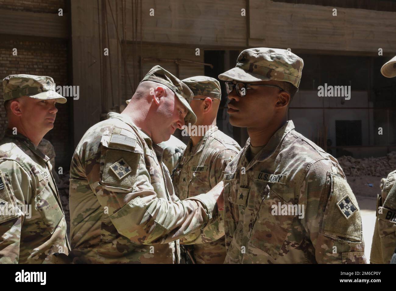 Lt. Col. Gregory Polk, the Task Force Pioneer commander, places a ...