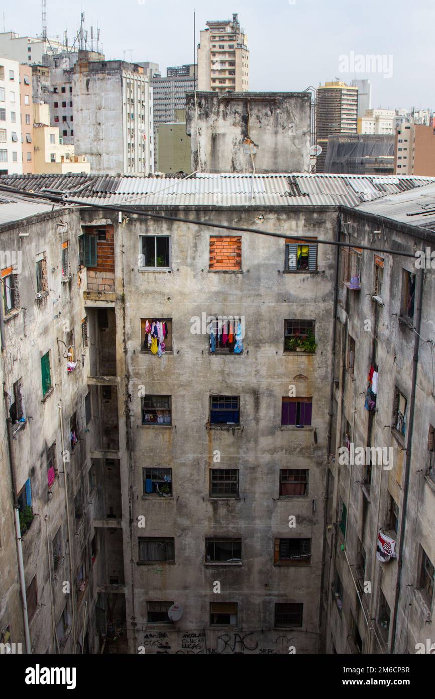 Worn building used as home by poor people Stock Photo - Alamy