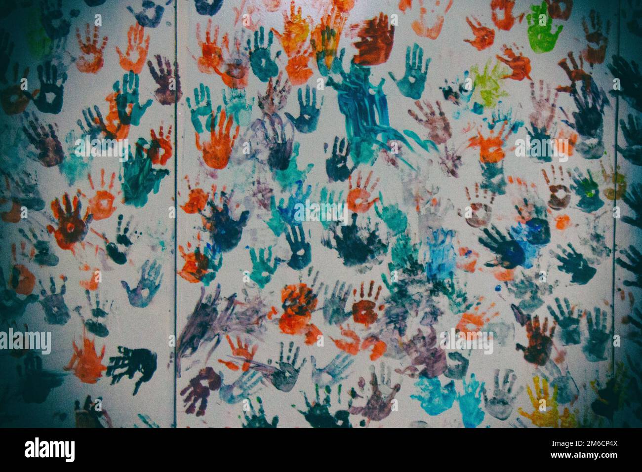 Wall painted by colourful children handprint Stock Photo - Alamy