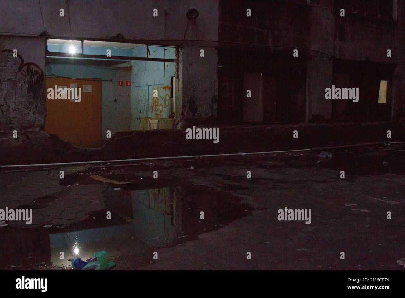 Condemned building window used as passage reflected on a puddle Stock ...