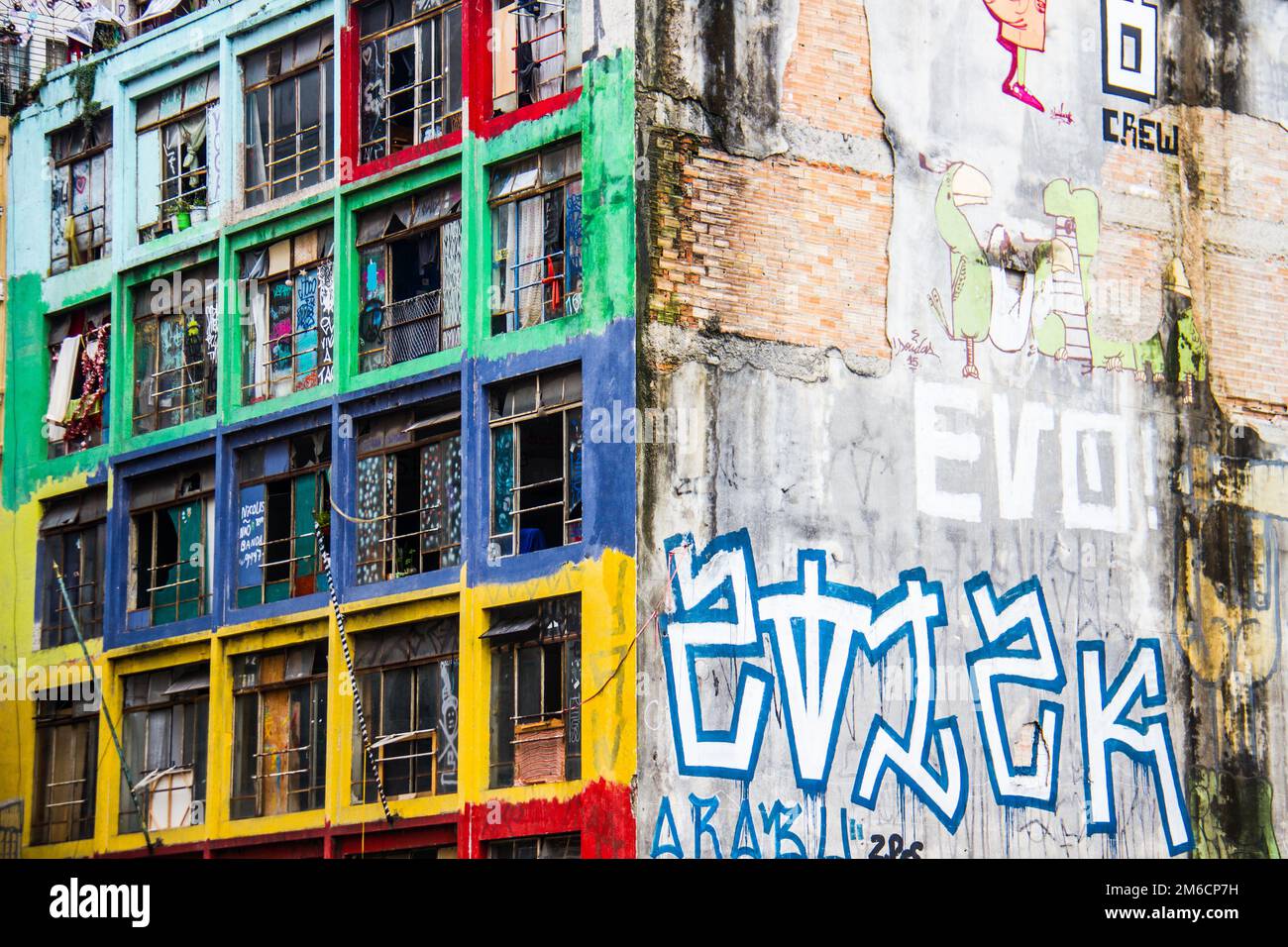 Occupied aged building colorful facade Stock Photo - Alamy