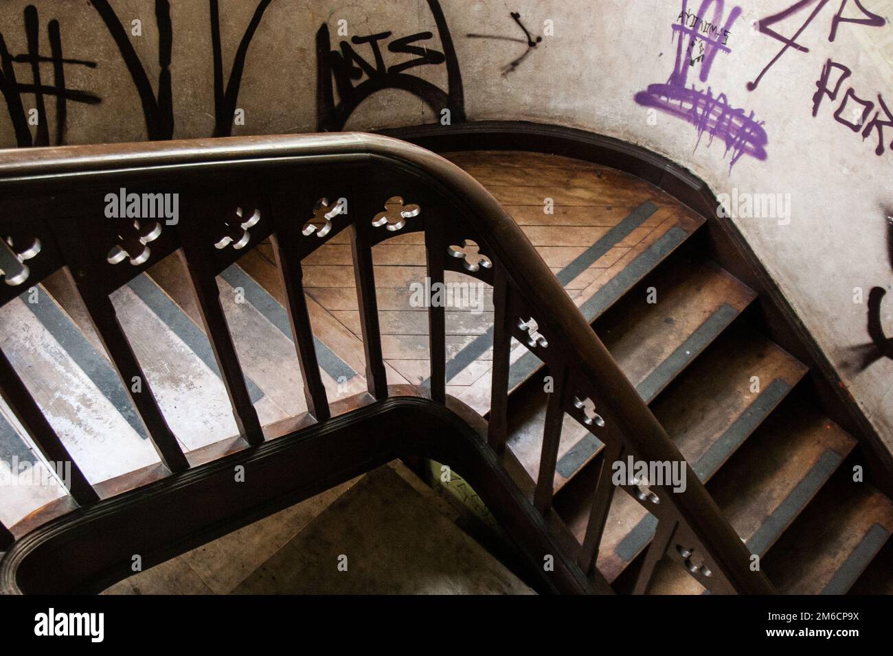 Graffiti on the walls of an old wooden staircase in abandoned house ...