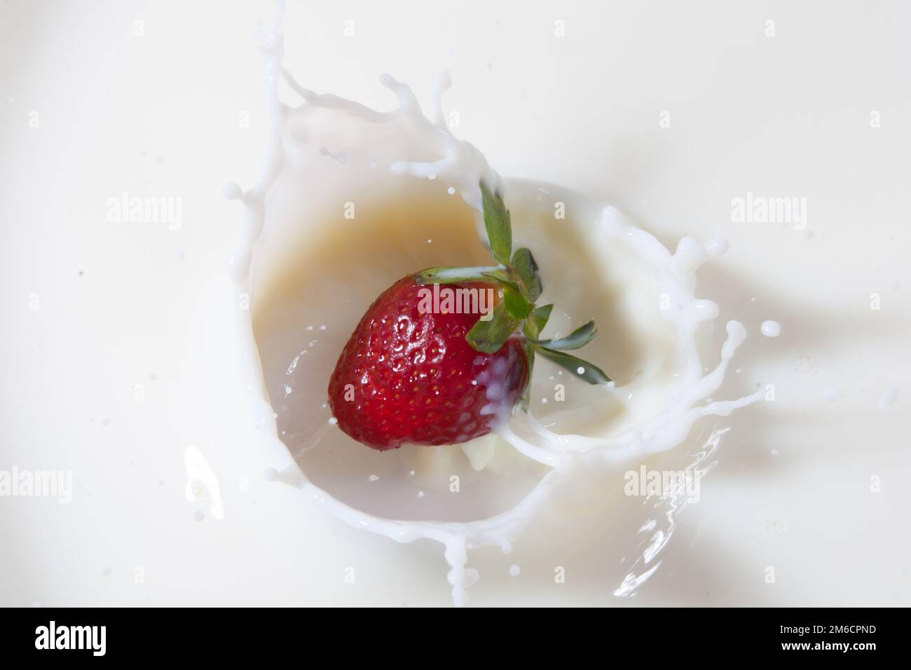 Red strawberry and white milk splash Stock Photo - Alamy