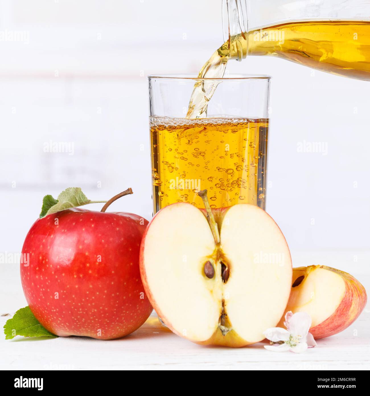 Apple juice pour pour apple juice apples fruit juice square Stock Photo ...