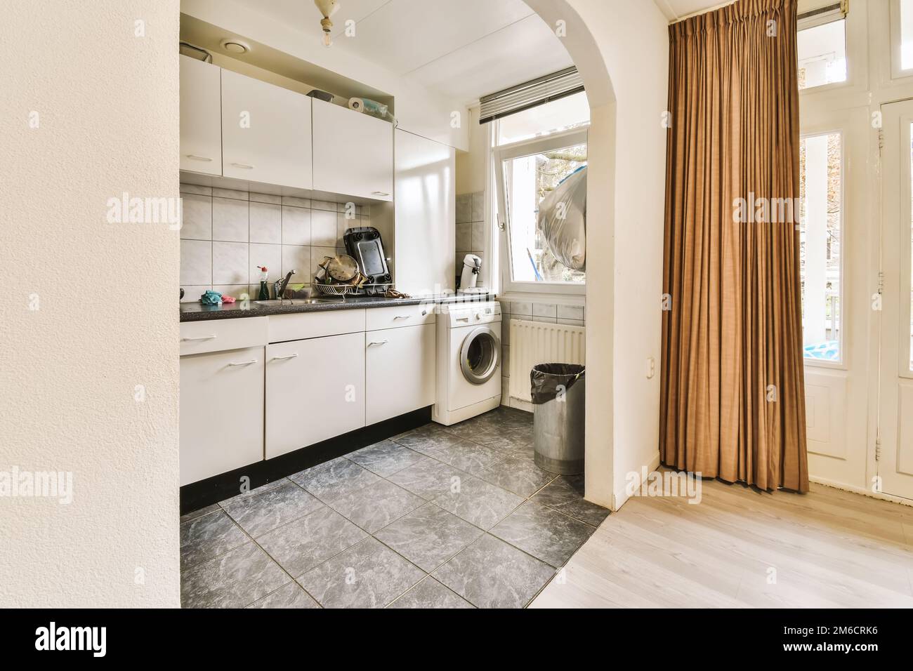 a laundry room with a washer, dryer and washing machine on the floor in ...