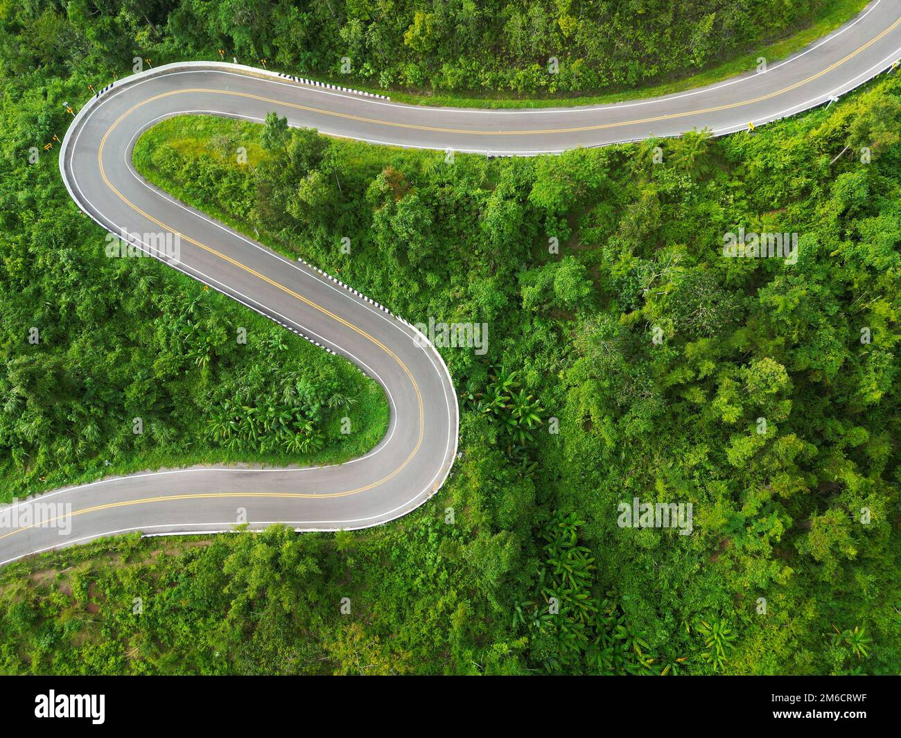 aerial view of a curved road in the mountain Stock Photo - Alamy