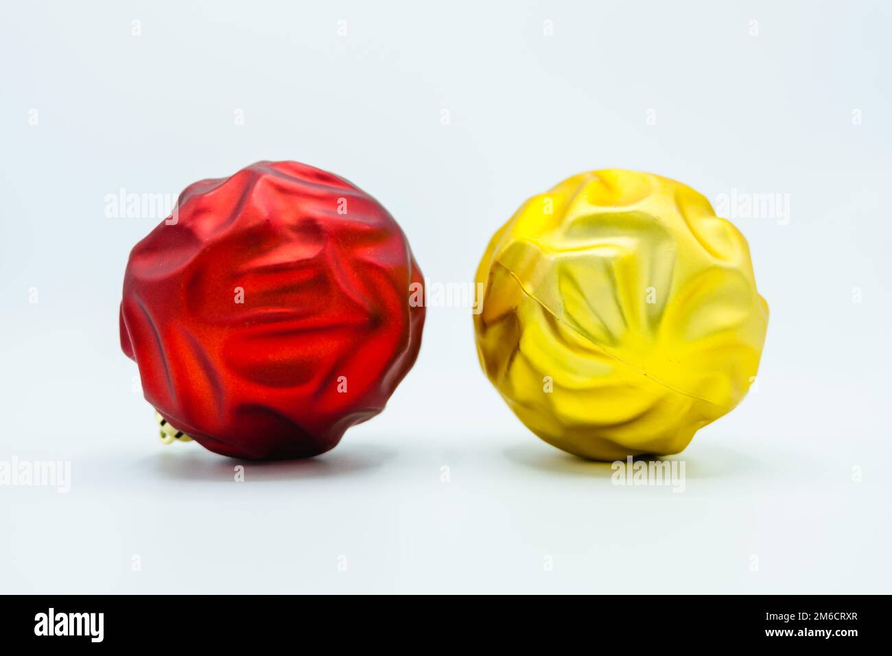 Red and yellow christmas tree ball on white Stock Photo - Alamy