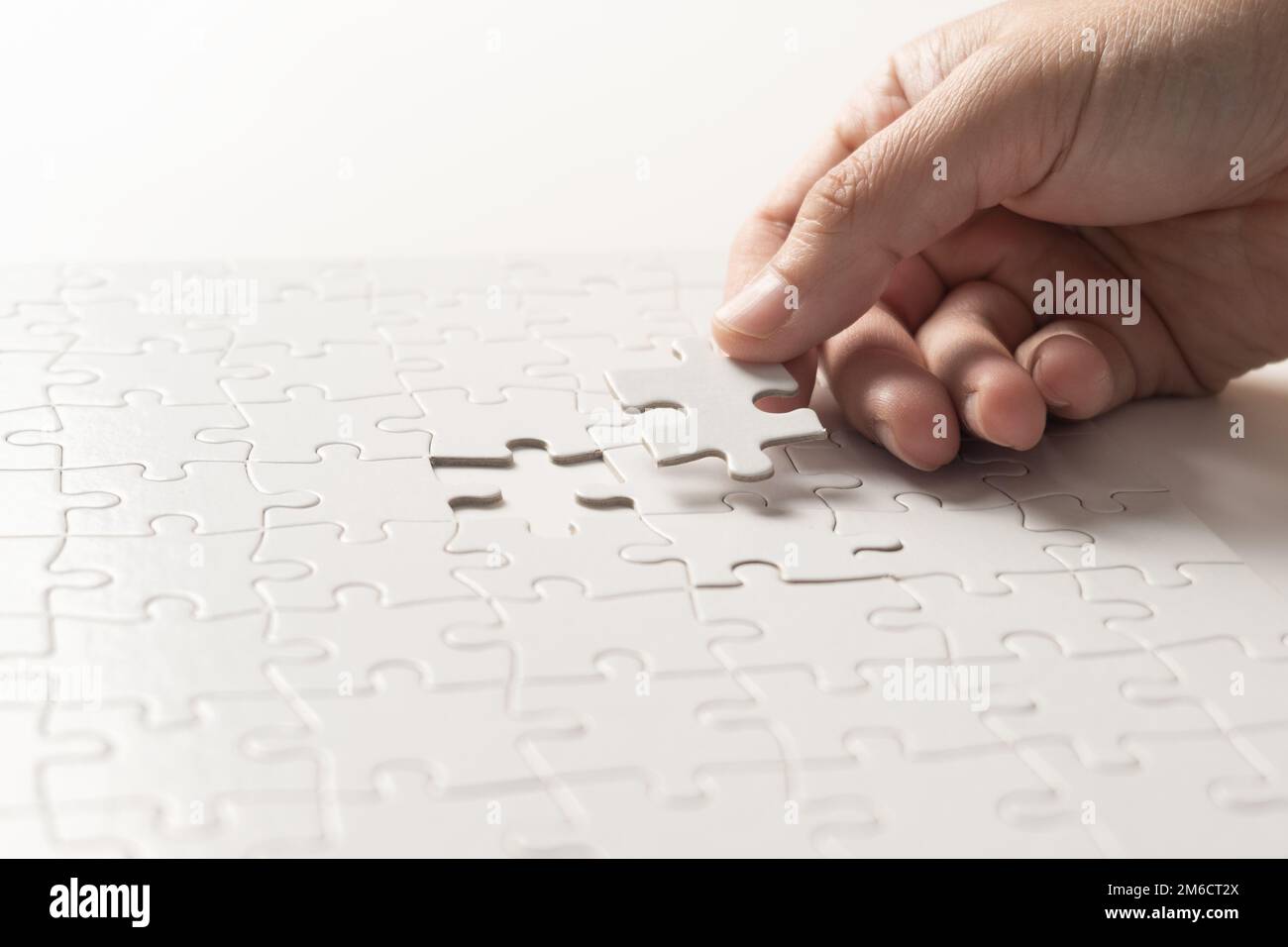 Completing jigsaw puzzle hi-res stock photography and images - Alamy