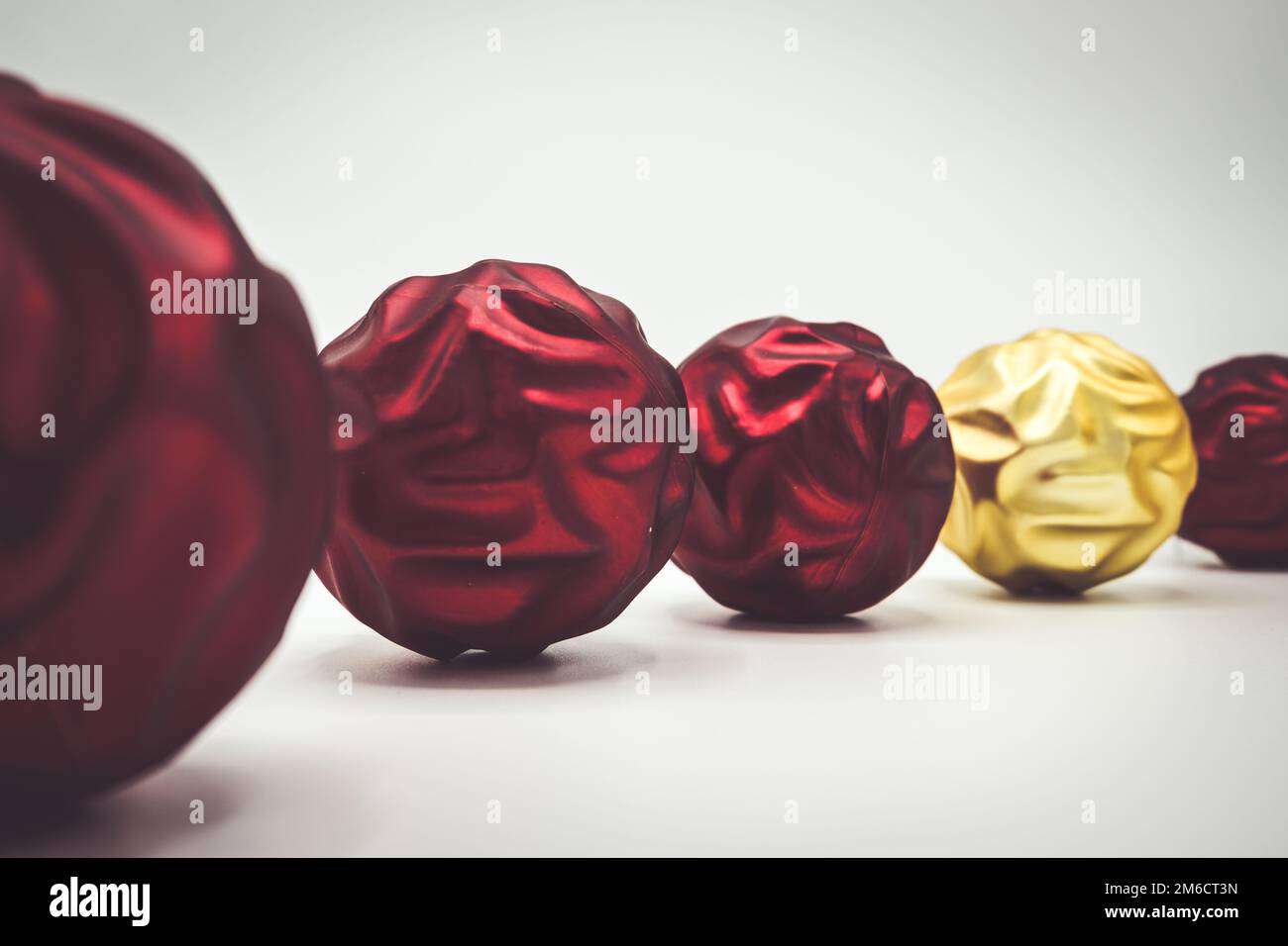 Desaturated wavy red and golden christmas balls on white Stock Photo ...