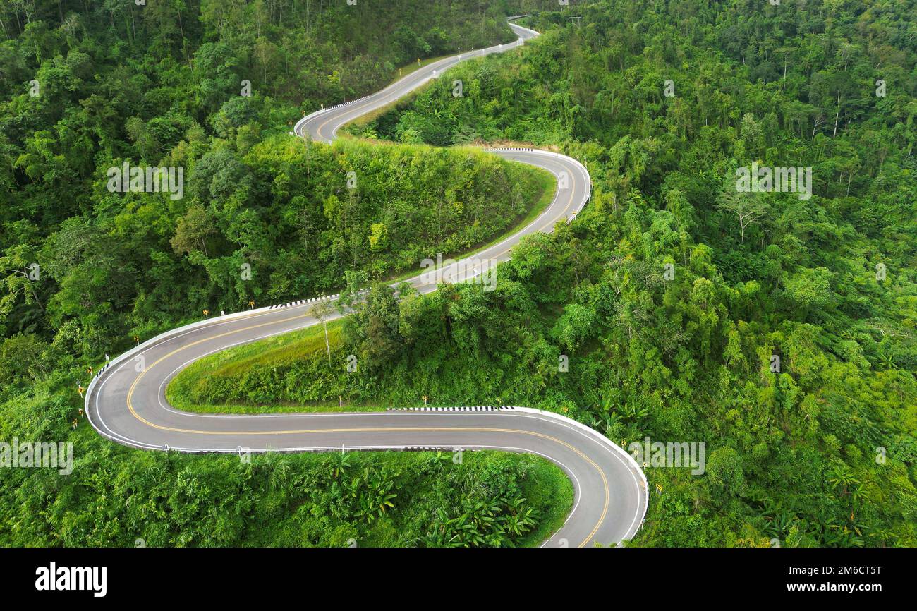 aerial view of a curved road in the mountain Stock Photo - Alamy