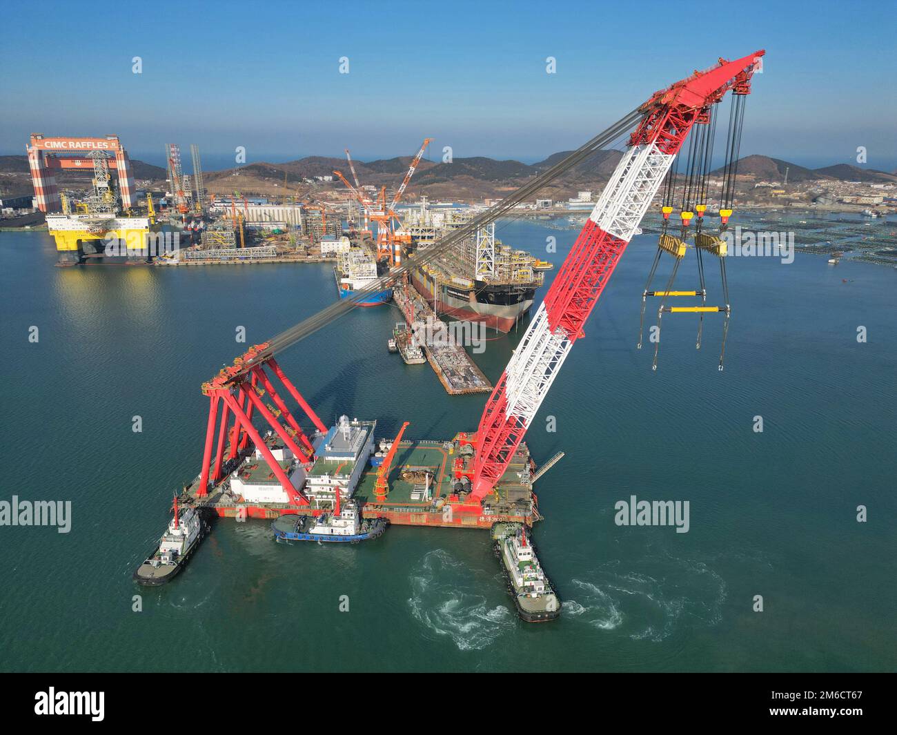 YANTAI, CHINA - JANUARY 3, 2023 - A large floating crane is used to shift the berth at the ...