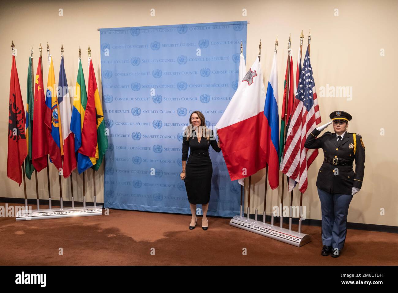 Malta Ambassador Vanessa Frazier stands next to his country flag during ...