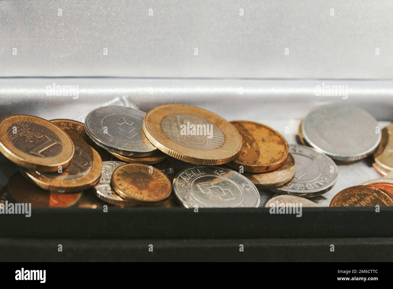 Coins in the box . Pile of metallic money Stock Photo - Alamy