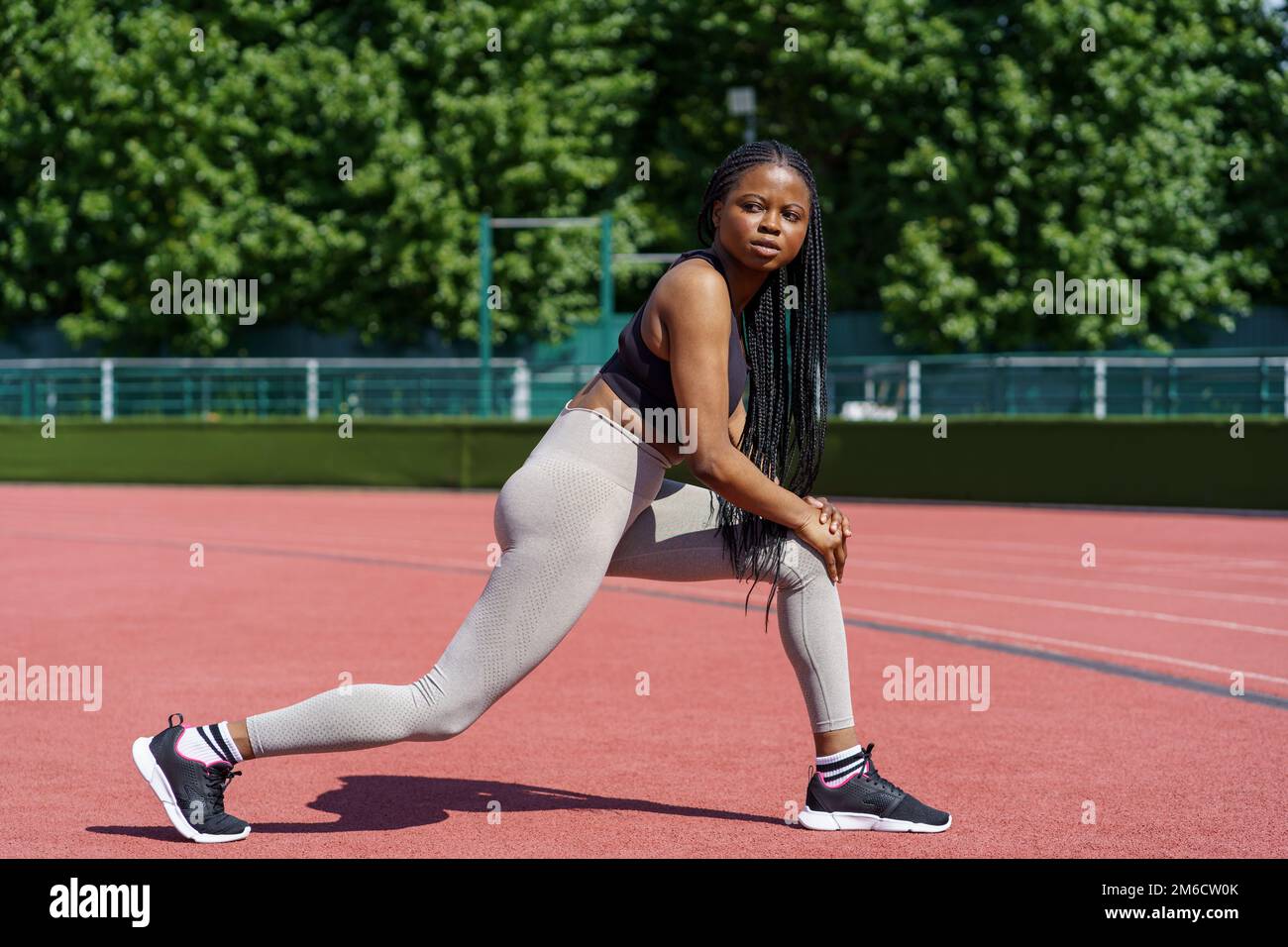 African American lady with long braids enjoys effective exercise for ...