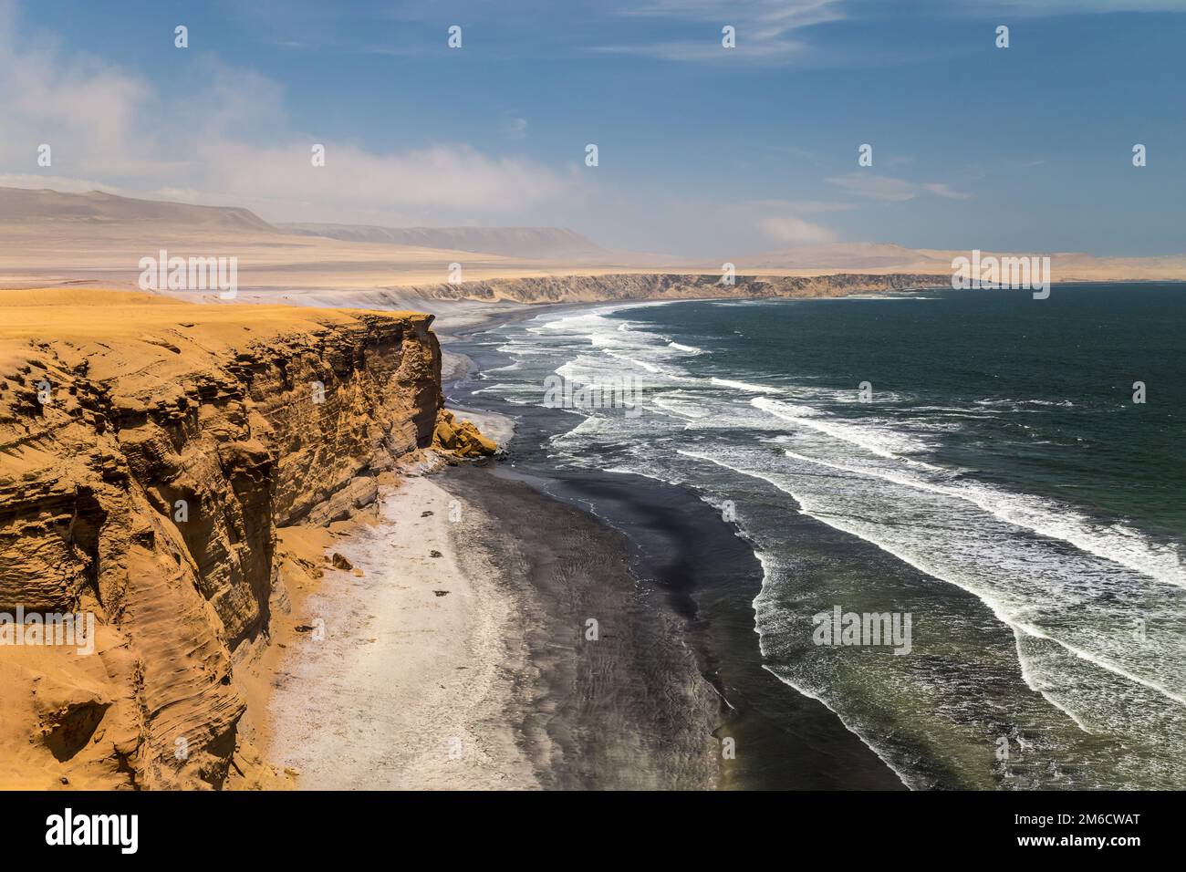 View to cliffs, desert and the Pacific ocean in Paracas national park ...
