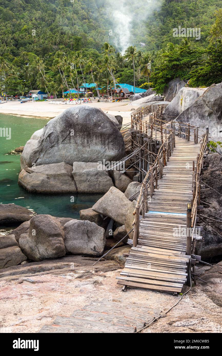Rustic wooden bridge crossing rocks on the way to a beach Stock Photo ...