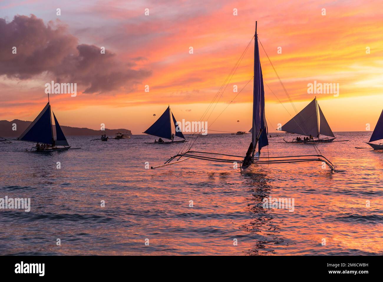 Small sailing boats at the sunset. Boracay, Philippines Stock Photo - Alamy