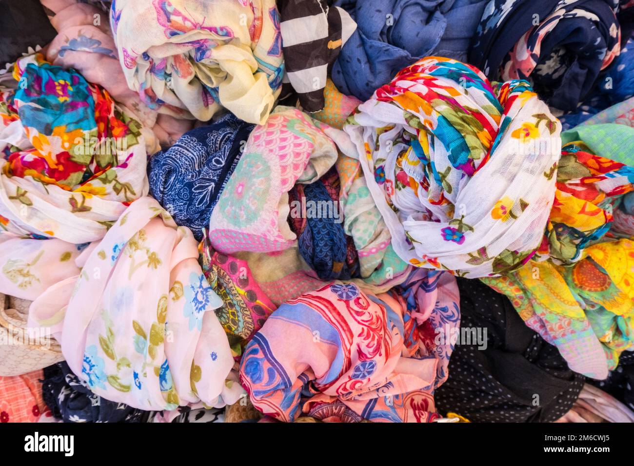 Multiple colors, fabric and textures of woman clothes at a street store ...