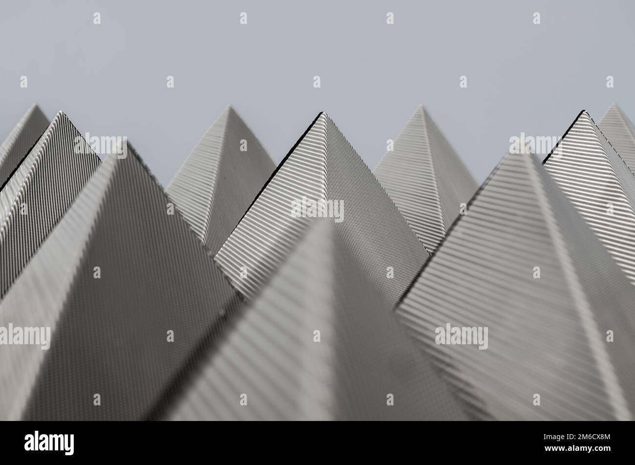 Symmetric, metallic, piramid pattern over grey sky in the Navarr Stock ...