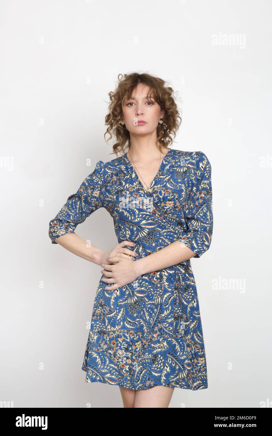 Serie of studio photos of young female model in colorful blue and white ...