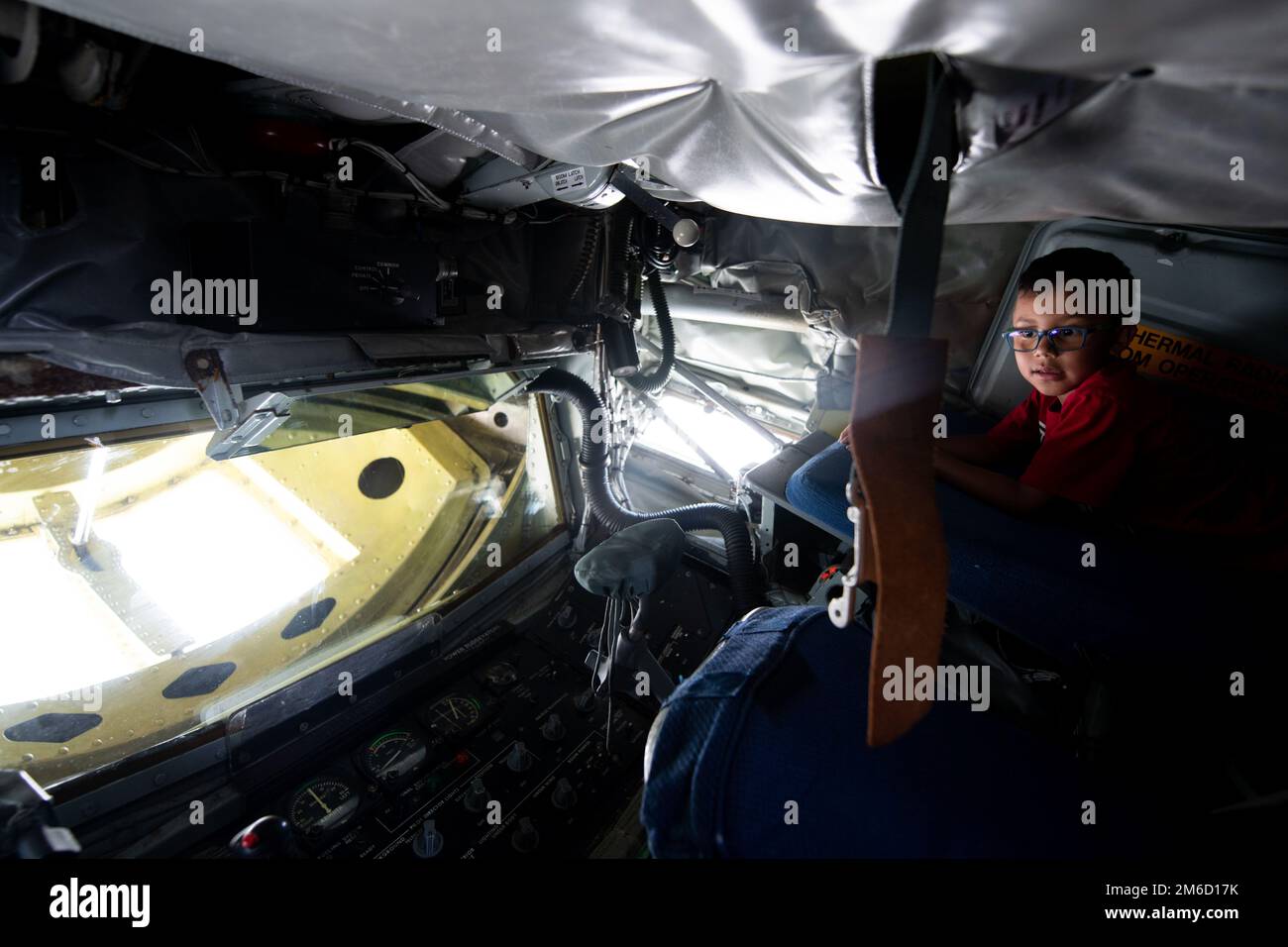 Ezra Oliveros inspects the boom-pod of a KC-135 Stratotanker from Altus ...