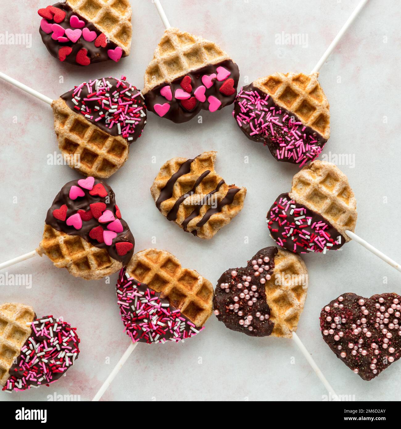 Heart shaped waffle pops forming a circle and one in the middle with a ...