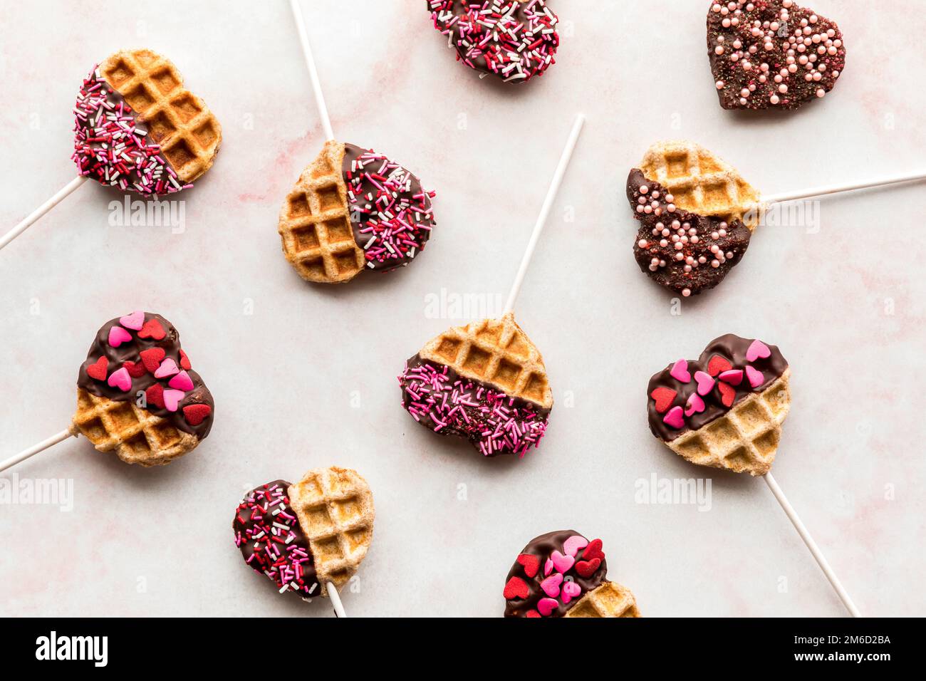 Top down view of decorated heart shaped waffle pops for Valentine's Day ...
