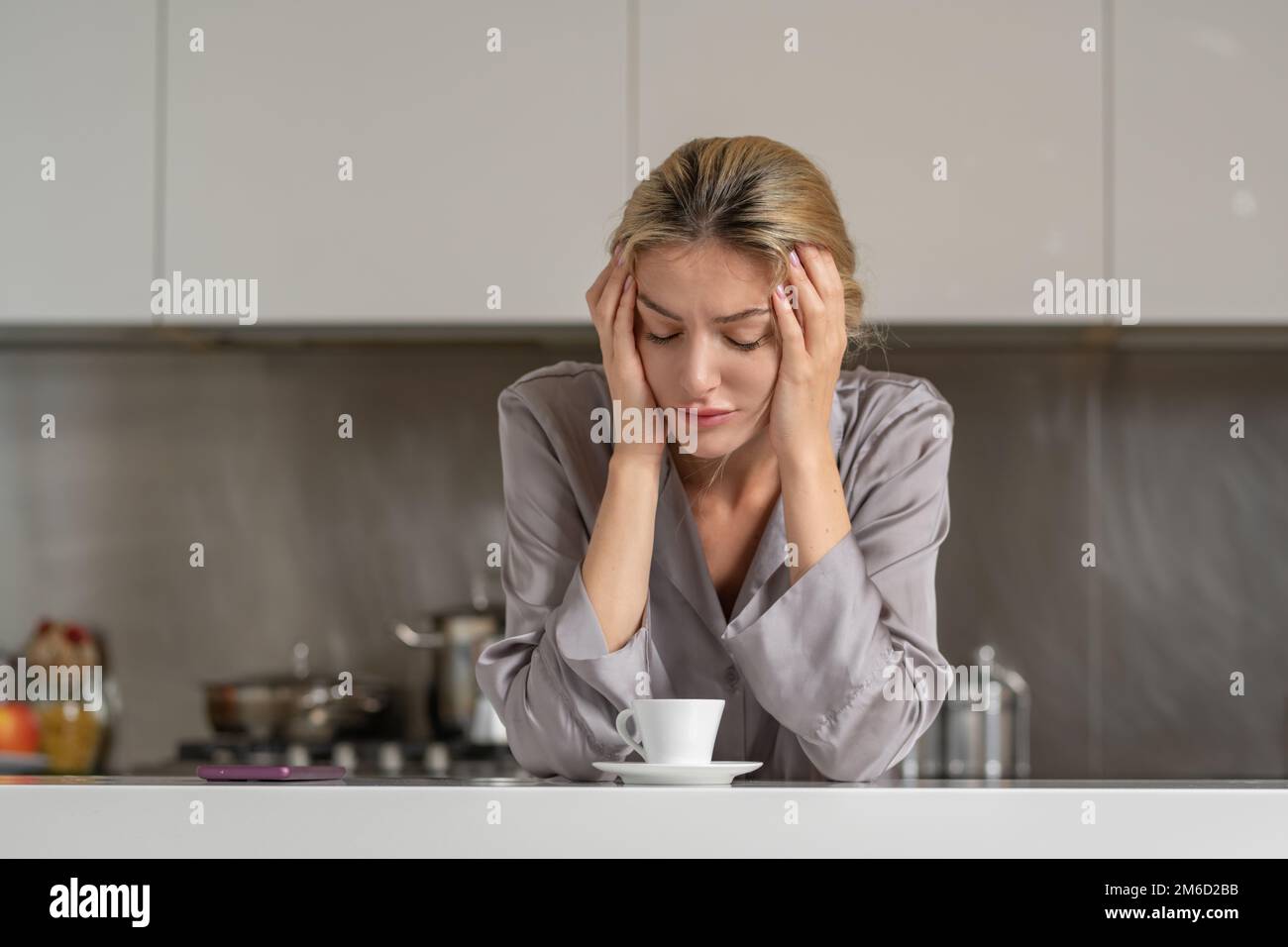 Bored depressed woman in the kitchen in the morning Stock Photo - Alamy