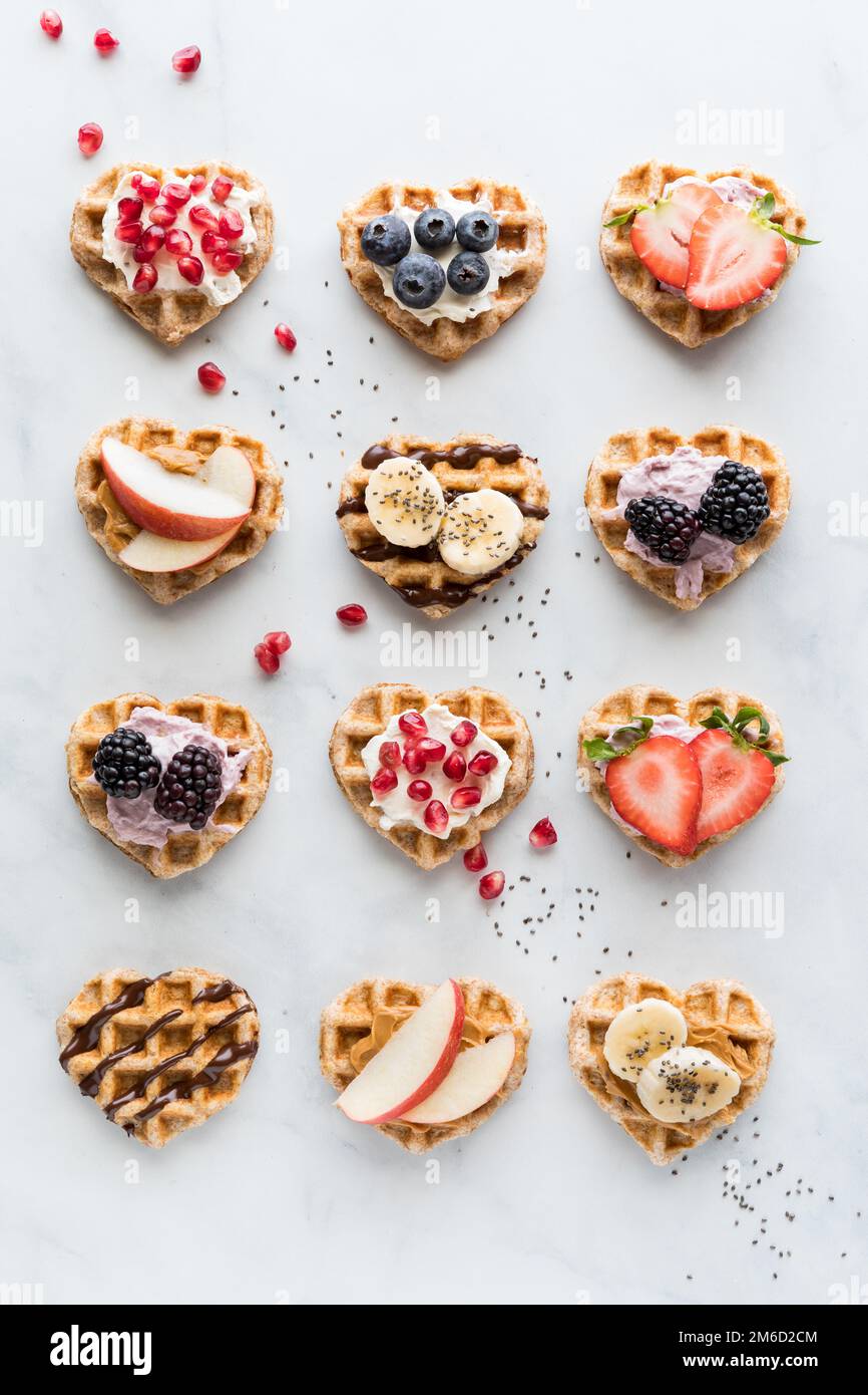 Heart shaped mini waffles with various toppings of spreads and fresh ...