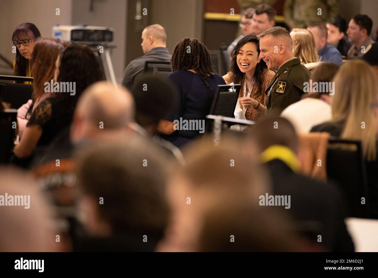 Soldiers and their Family members participate in a group activity while ...
