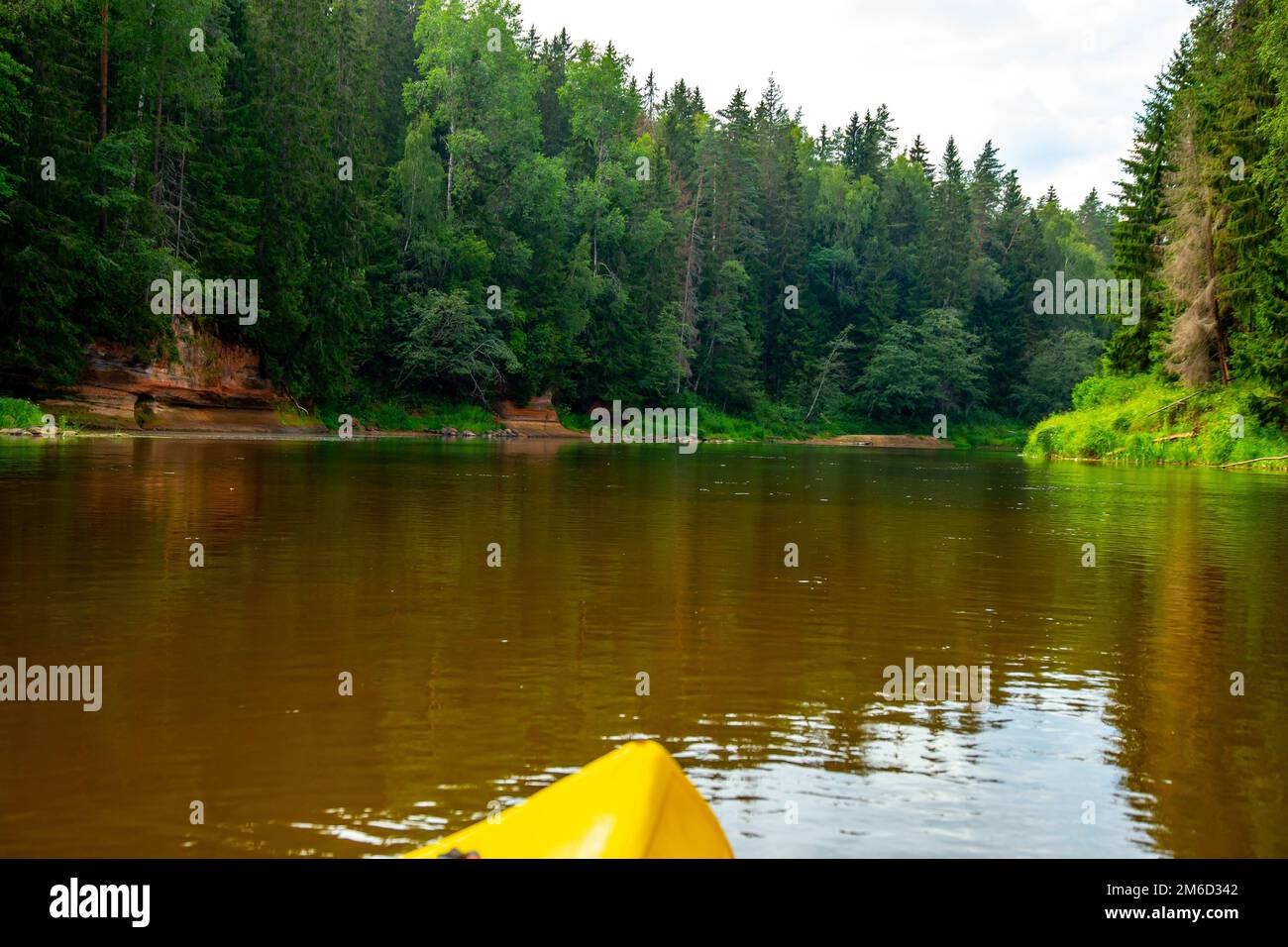 Yellow boat ride by the river Stock Photo - Alamy