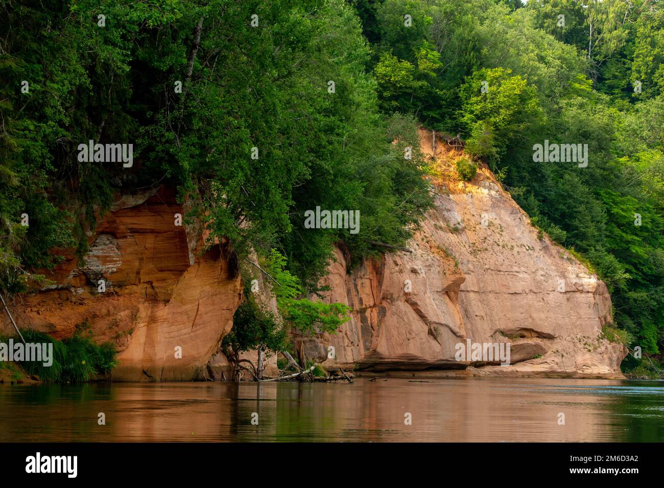 Red sandstone cliff on coast of the river Stock Photo - Alamy