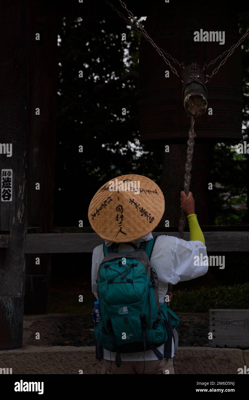 A pilgrim in traditional clothes but with a modern backpack visits the ...