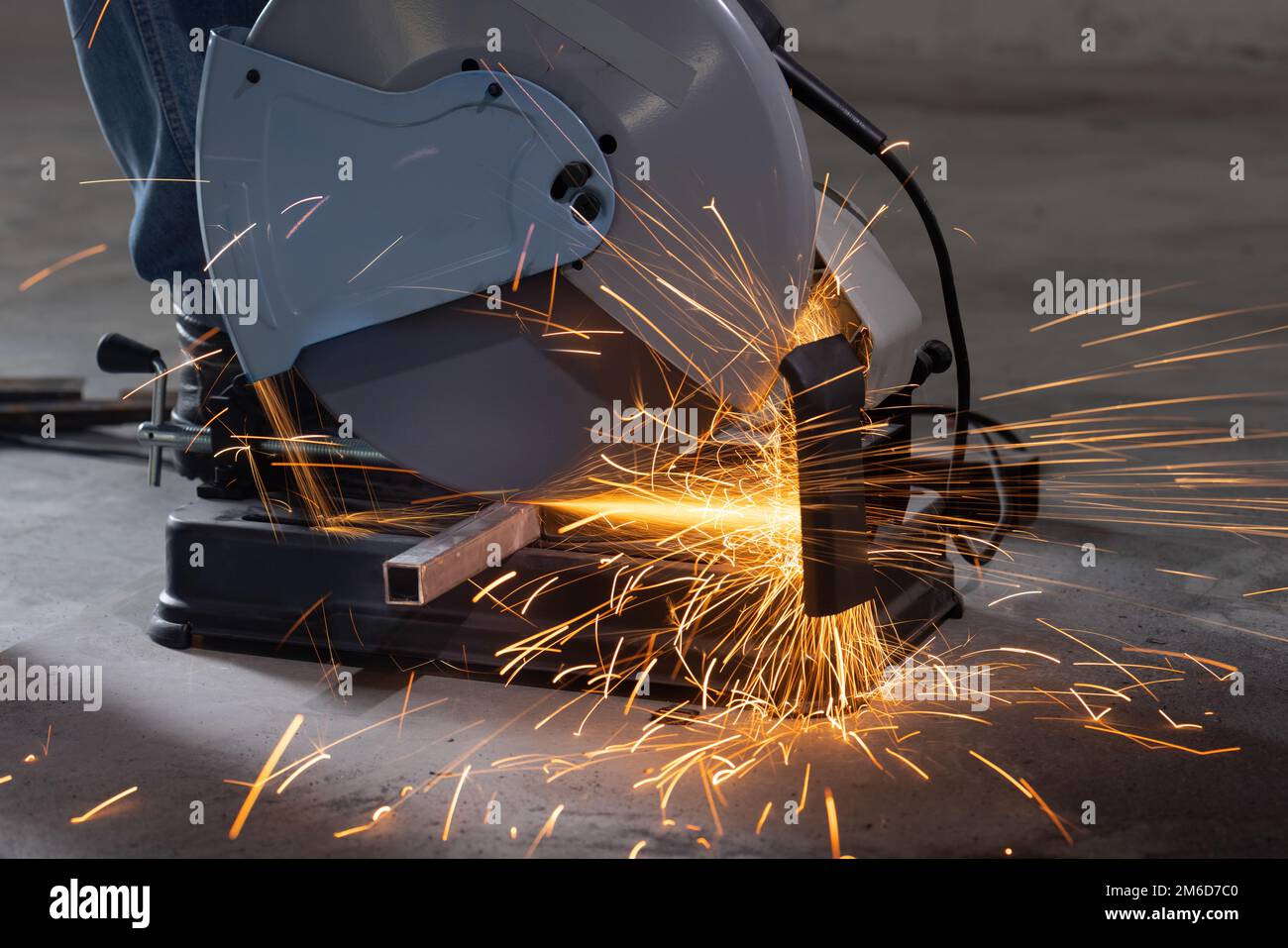 Worker cutting steel rectangular pipe in construction site Stock Photo ...
