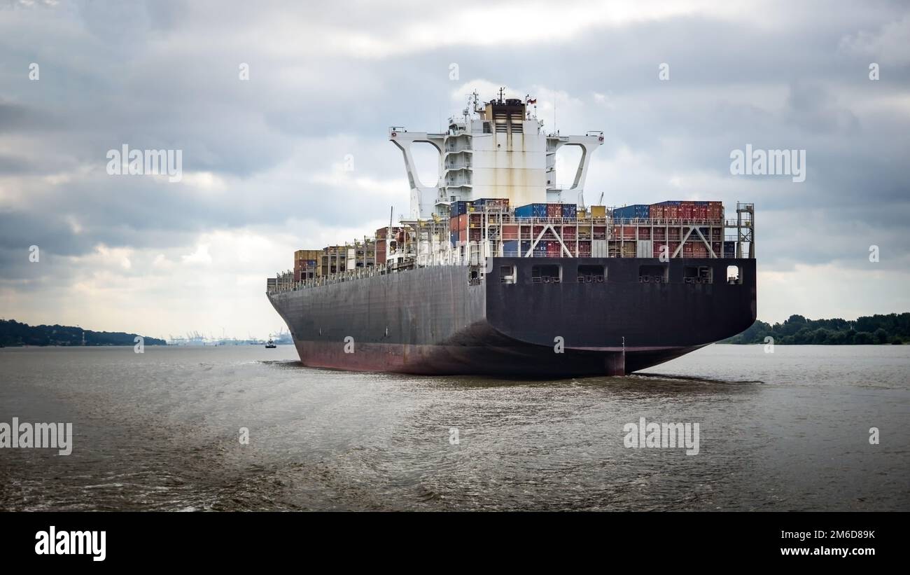 Container ship from behind on the Elbe river Stock Photo - Alamy