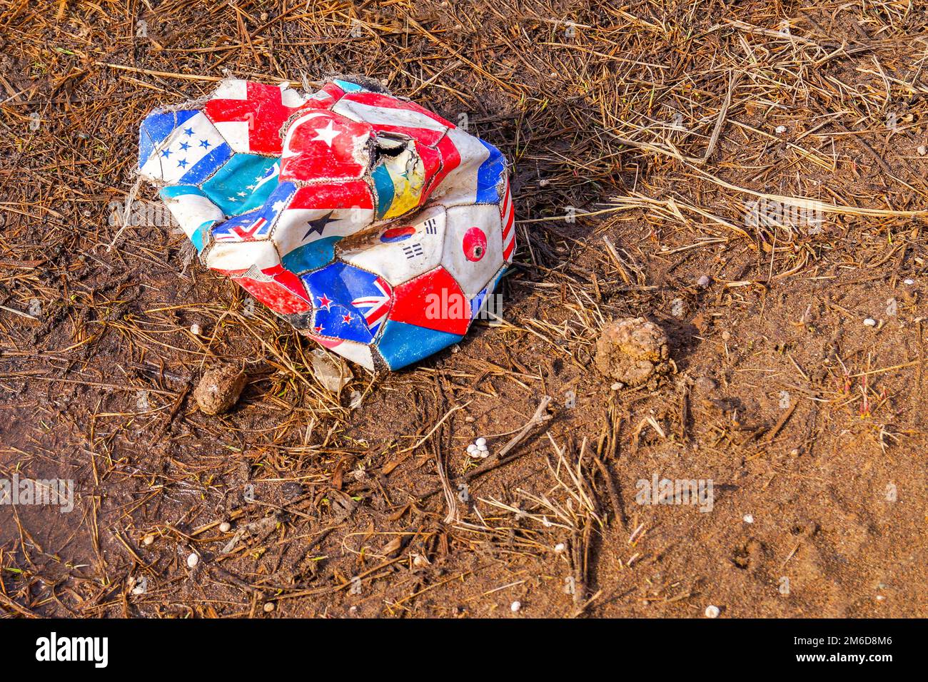 A broken and thrown old soccer ball lies on the ground Stock Photo - Alamy