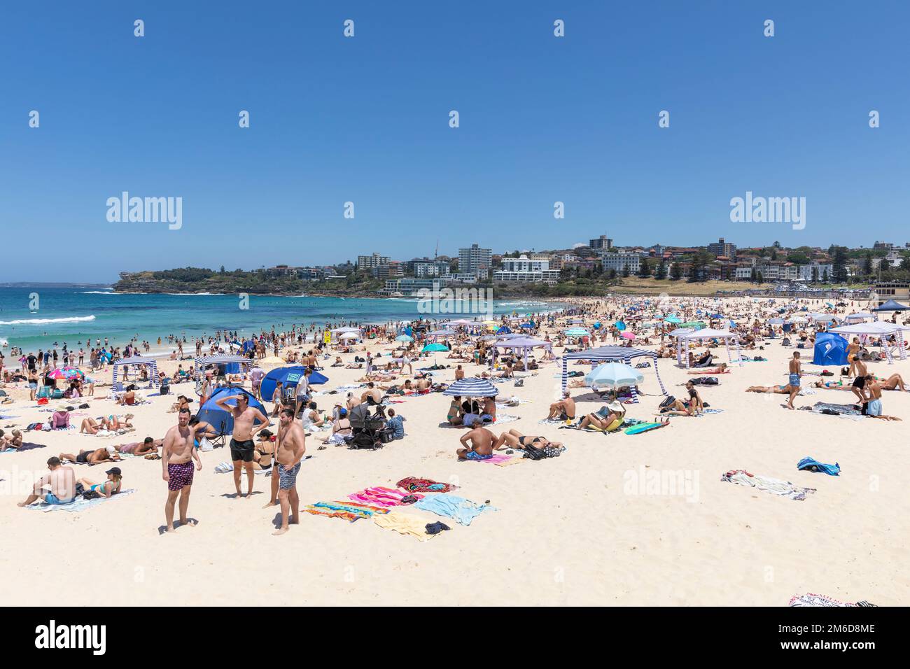 Iconic Bondi Beach in Sydney eastern suburbs, blue sky summers day 2023, crowds flock to the ...