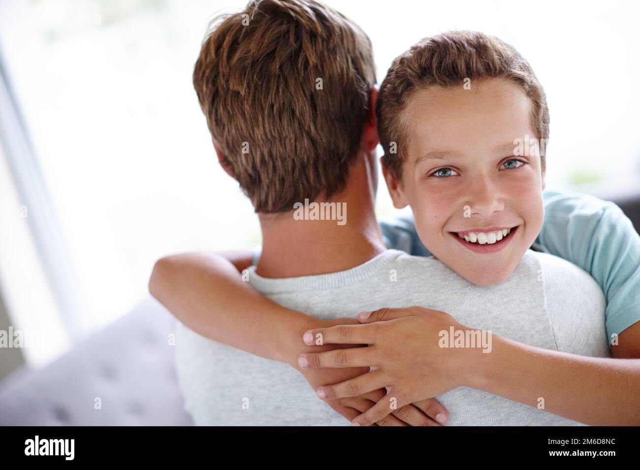 Dad is a sons first hero. Portrait of a happy little boy hugging his ...