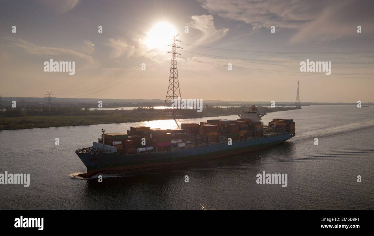 Container ship on the Elbe in service at sunset Stock Photo - Alamy