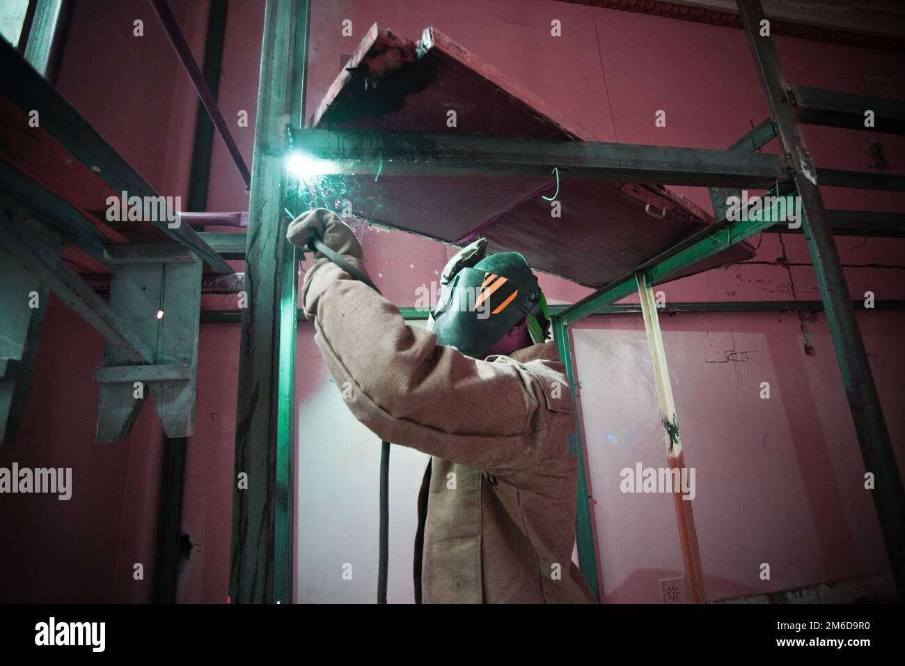 Welder in mask welding metal construction on open air Stock Photo - Alamy