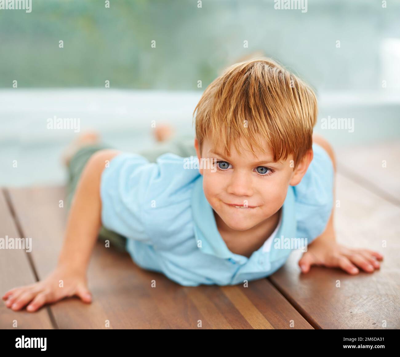Having fun at home. A cute young boy playing on the dinner table at ...