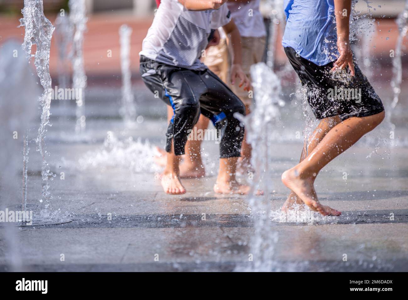 The hot summer. The boys in the outdoor fountain, soaking wet, playing ...
