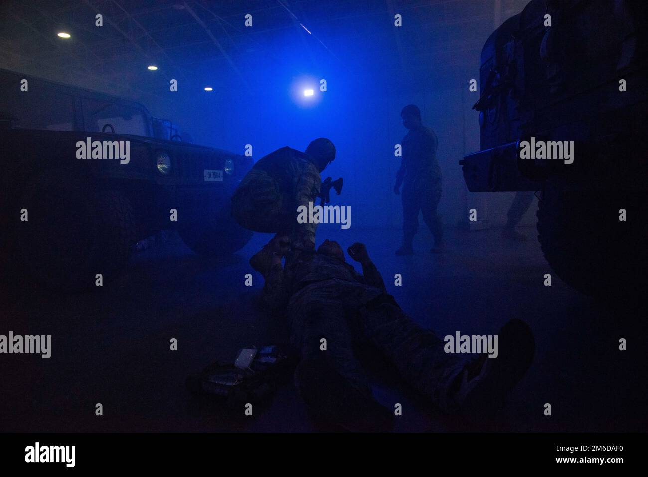 A Tactical Combat Casualty Care student carries a simulated casualty to ...