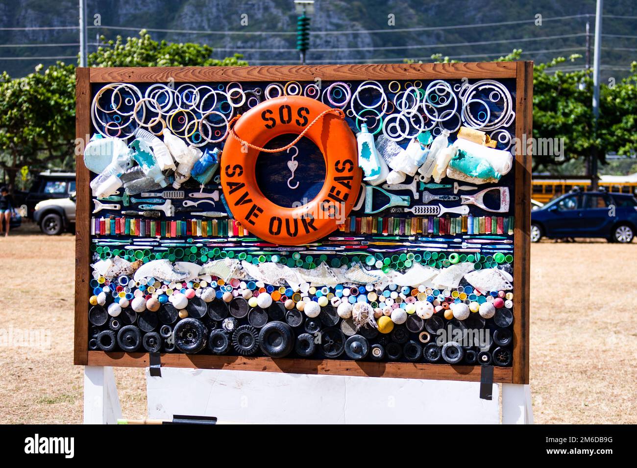 A sign made of trash is displayed during a beach clean-up event at ...