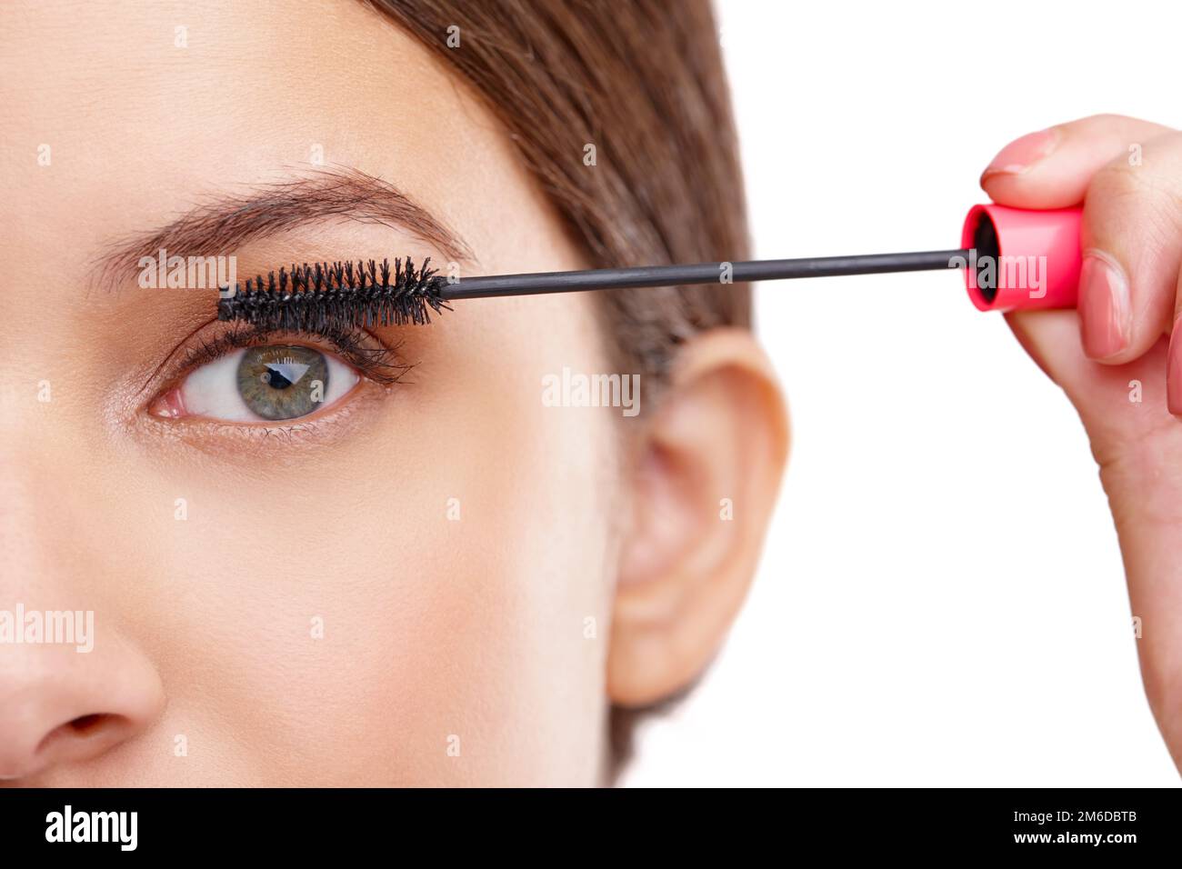 The magic mascara wand. Closeup studio shot of a beautiful young woman ...