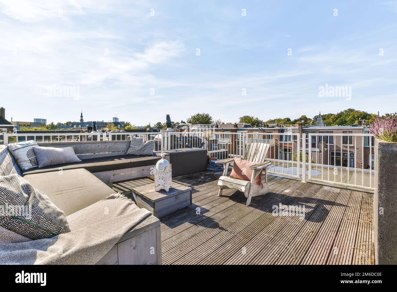 a rooftop with couches, chairs and tables on the top deck looking out ...